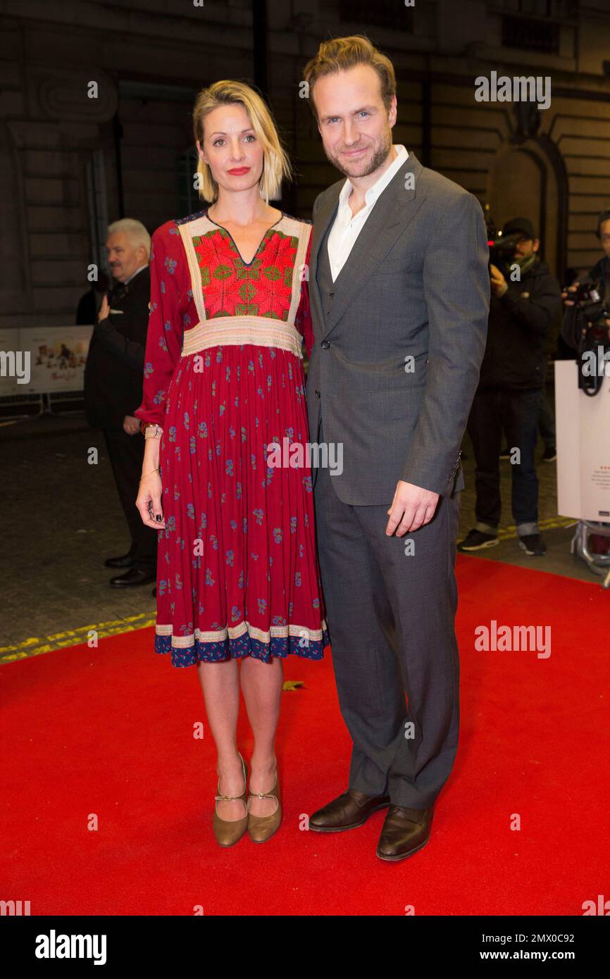 Actor Rafe Spall, right, and wife Elize du Toit pose for photographers ...