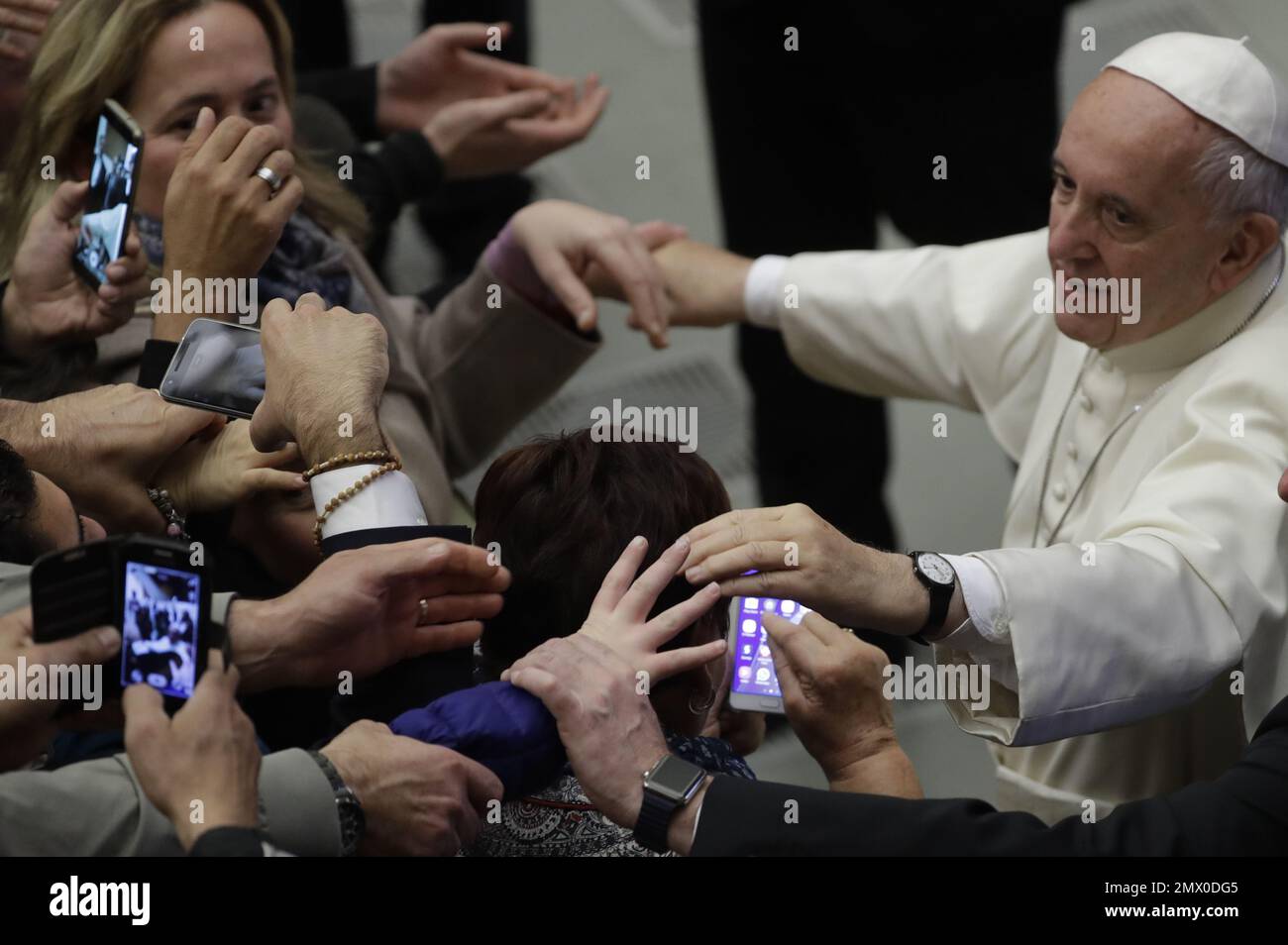 Pope Francis shakes hands with the faithful at the end of his weekly ...
