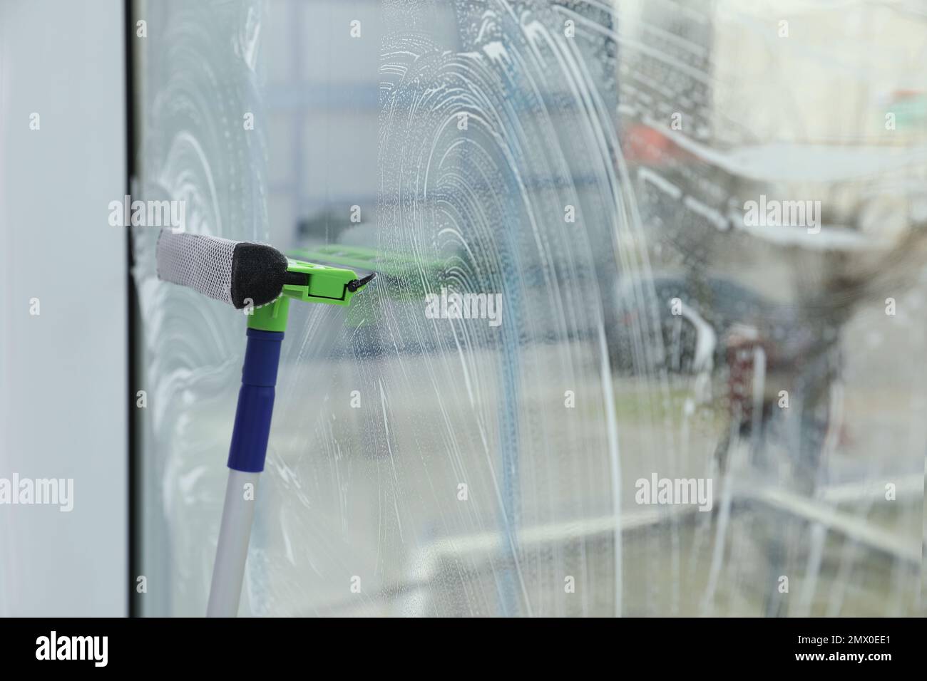 Cleaning window with squeegee indoors. Space for text Stock Photo - Alamy