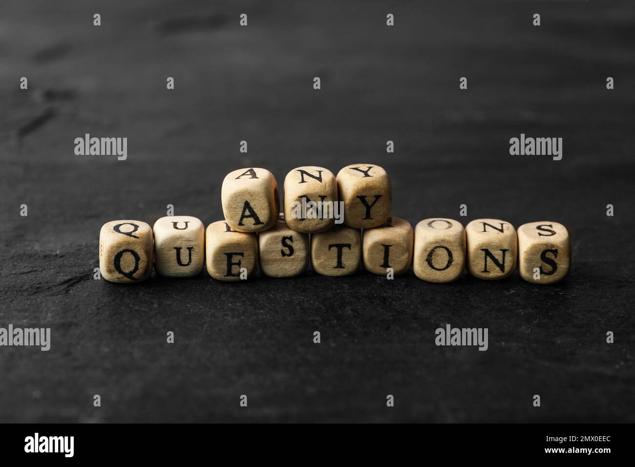 Wooden cubes with phrase ANY QUESTIONS on black stone table Stock Photo ...