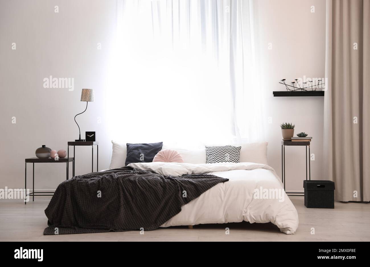 Stylish room interior with big comfortable bed Stock Photo - Alamy