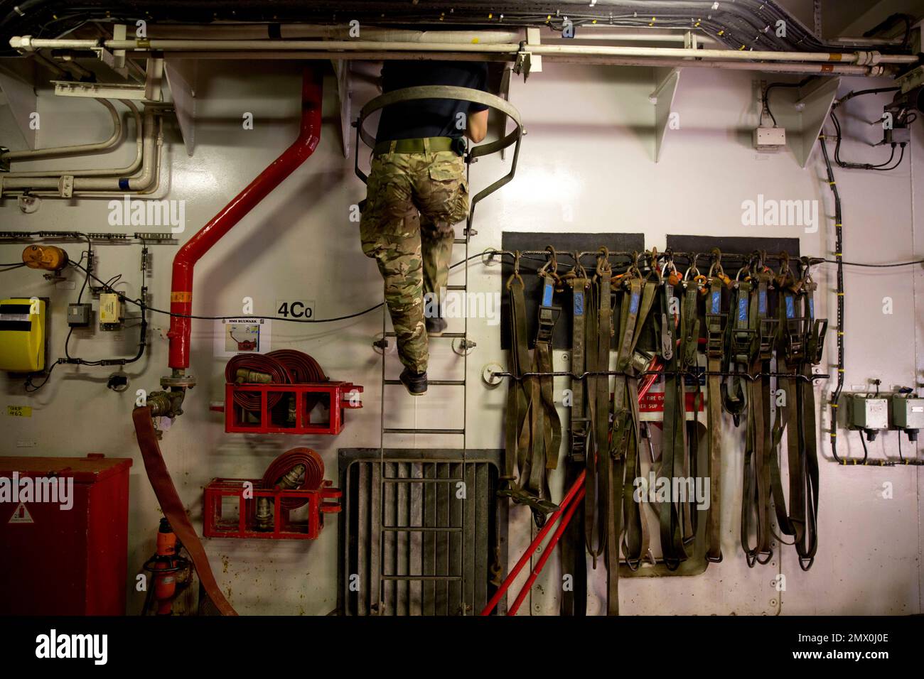 A navy officer climbs inside the British Royal Navy amphibious assault ...