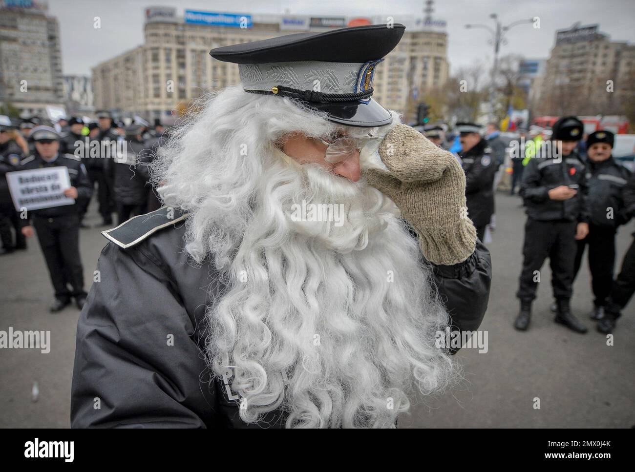 A Romanian policeman wears a false beard and glasses covered in tape to ...