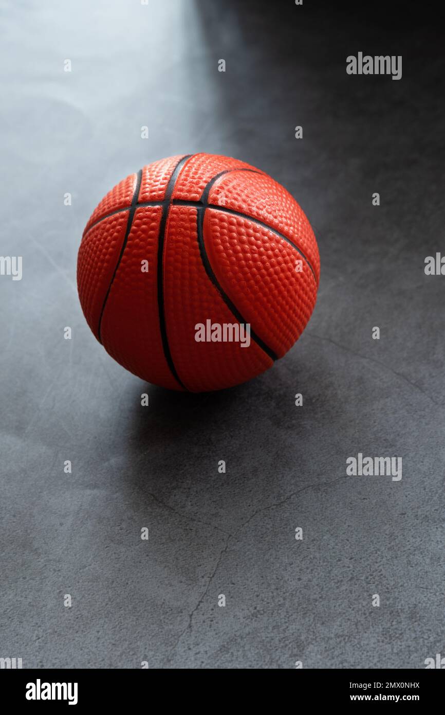 Small soft foam basketball on dark background Stock Photo - Alamy