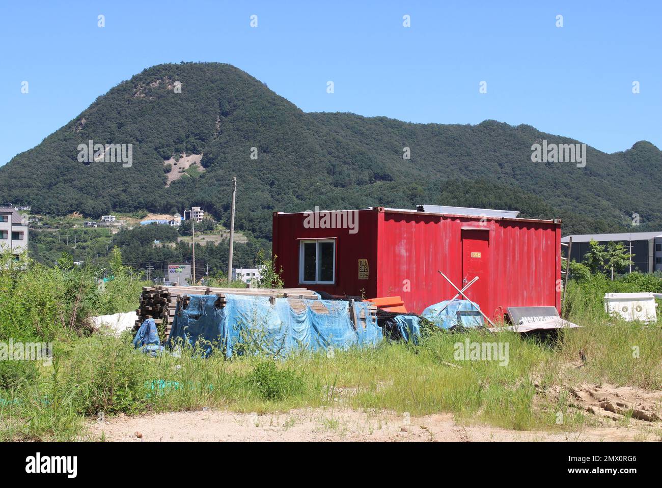 Red shipping container office in construction area Stock Photo - Alamy