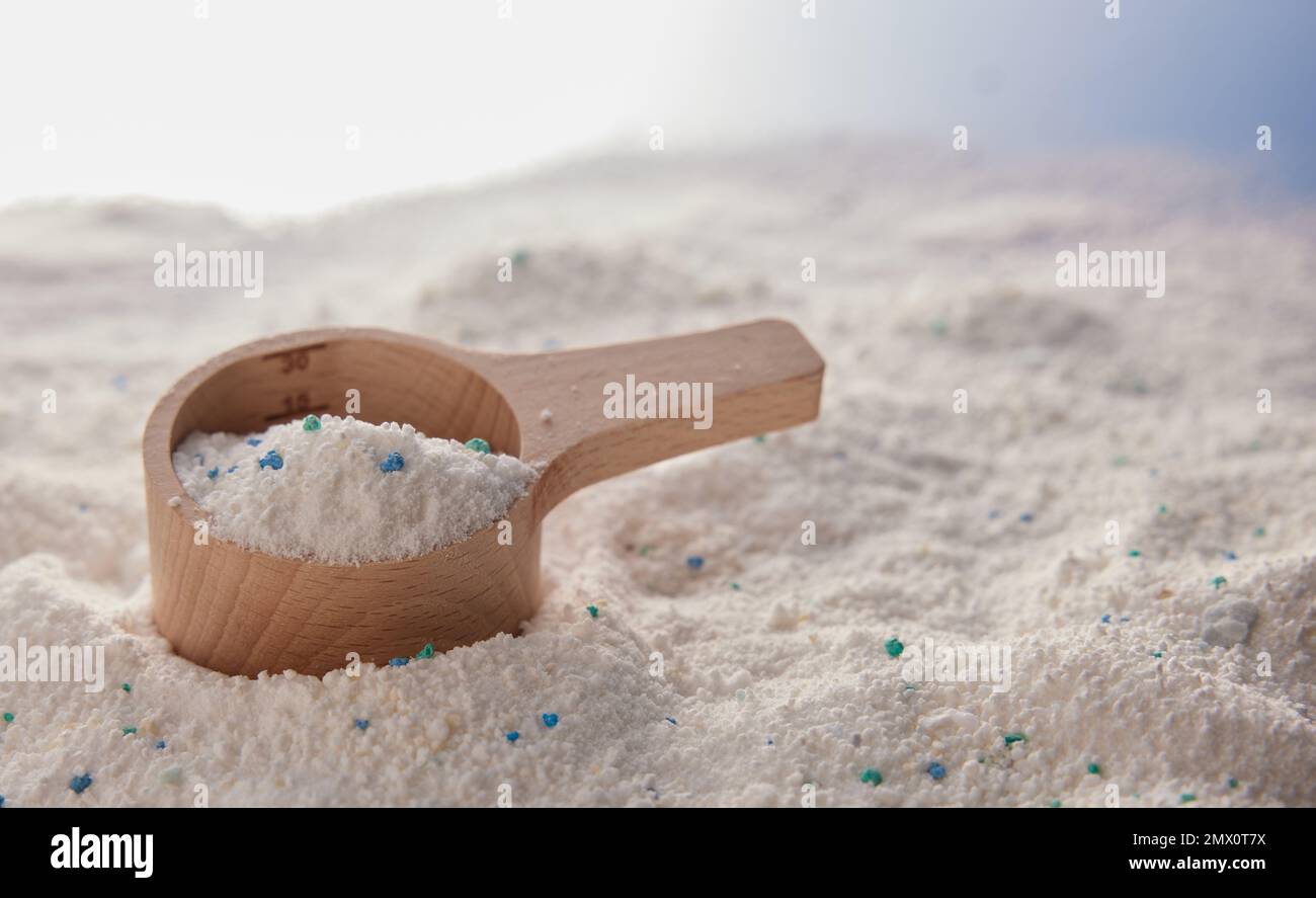 Heap of antibacterial soap powder for daily laundry routine with wooden ...