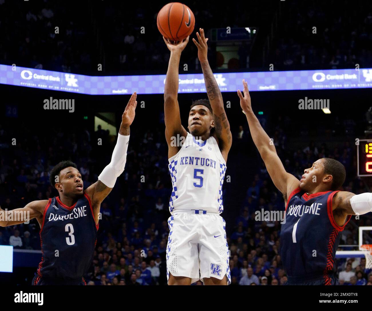 Kentucky's Malik Monk (5) shoots between Duquesne's Tarin Smith (3) and ...