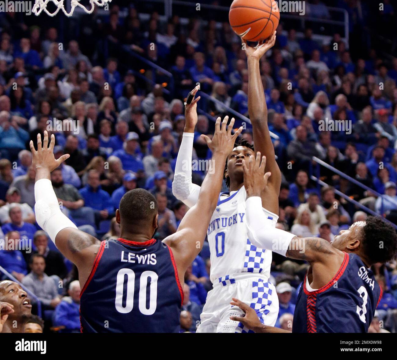 Kentucky's De'Aaron Fox, center, shoots near Duquesne's Darius Lewis ...