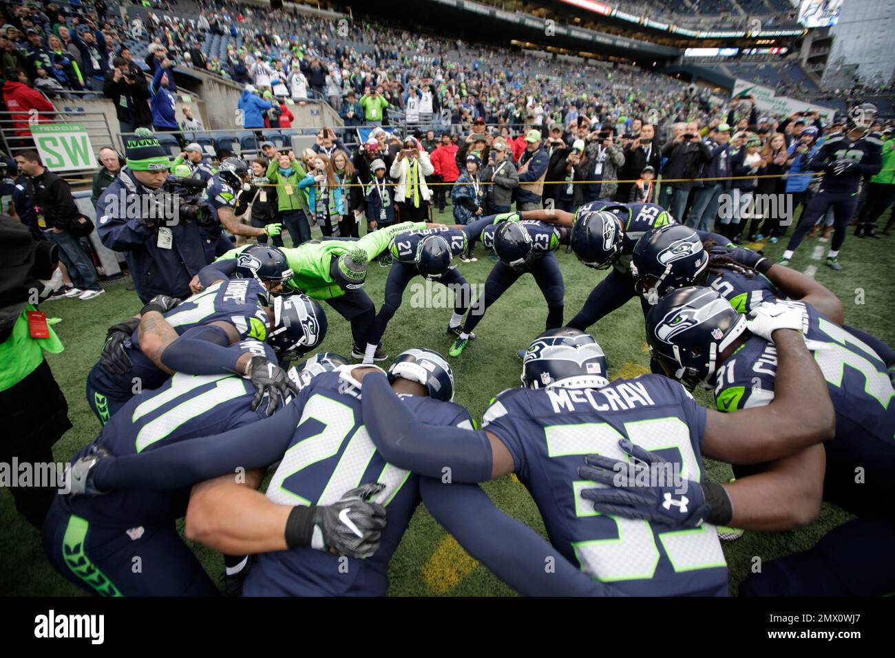 Seattle Seahawks players huddle as they take the field during warmups ...