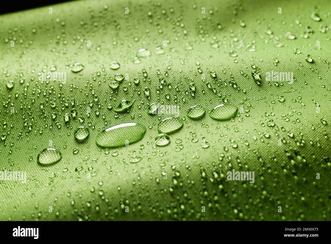 From above closeup abstract wet green background with drops of water on ...