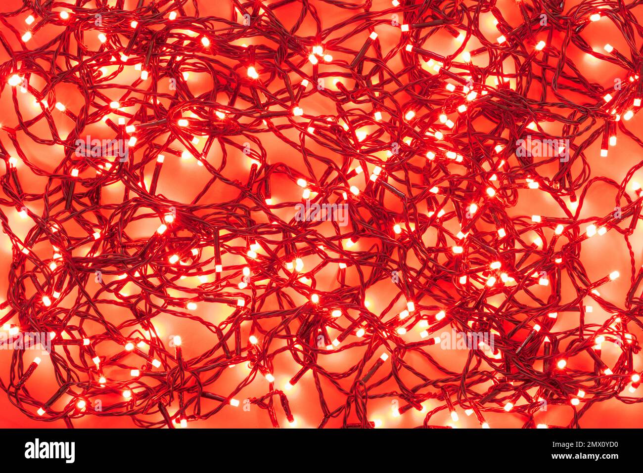 Tangled wire garlands with red light bulbs on a red background Stock ...