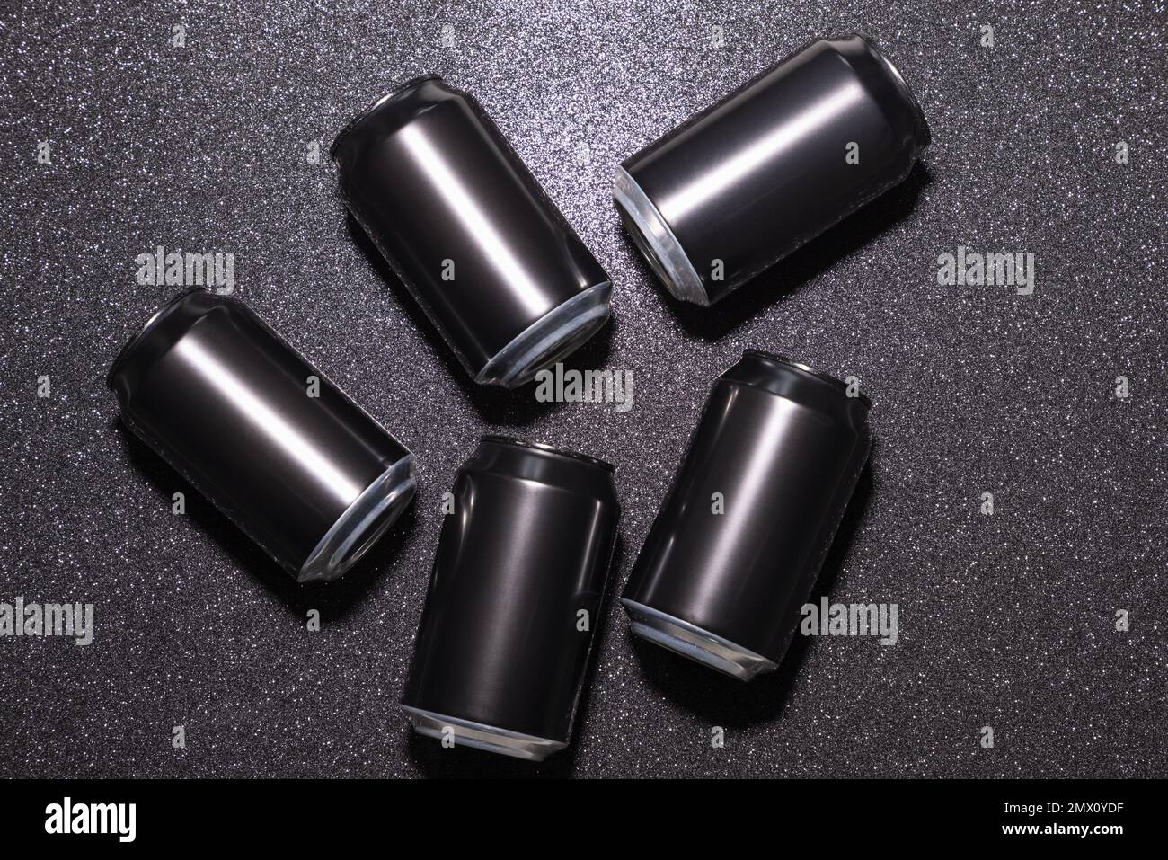 Black aluminium soda cans on a black background with sparkles, view ...