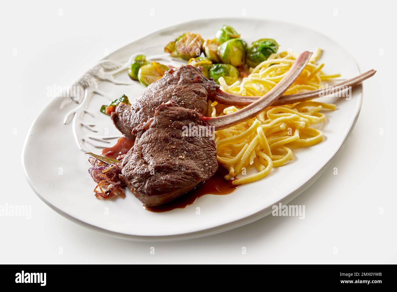 Tasty fried ribeye deer tomahawk steaks with spaghetti and Brussels ...