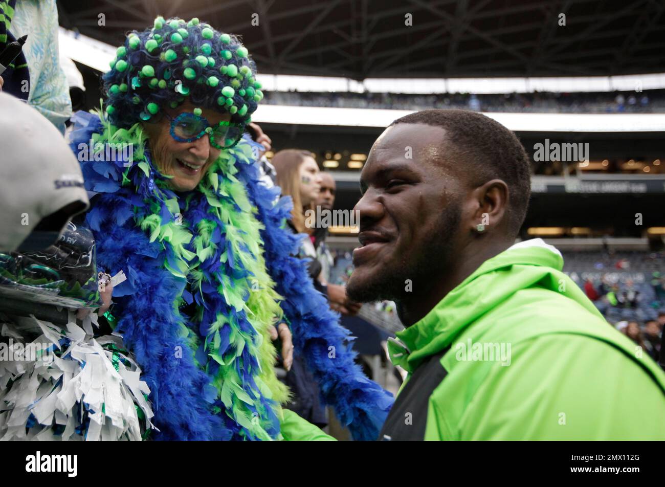Seattle Seahawks defensive end Frank Clark talks with Seahawks superfan ...