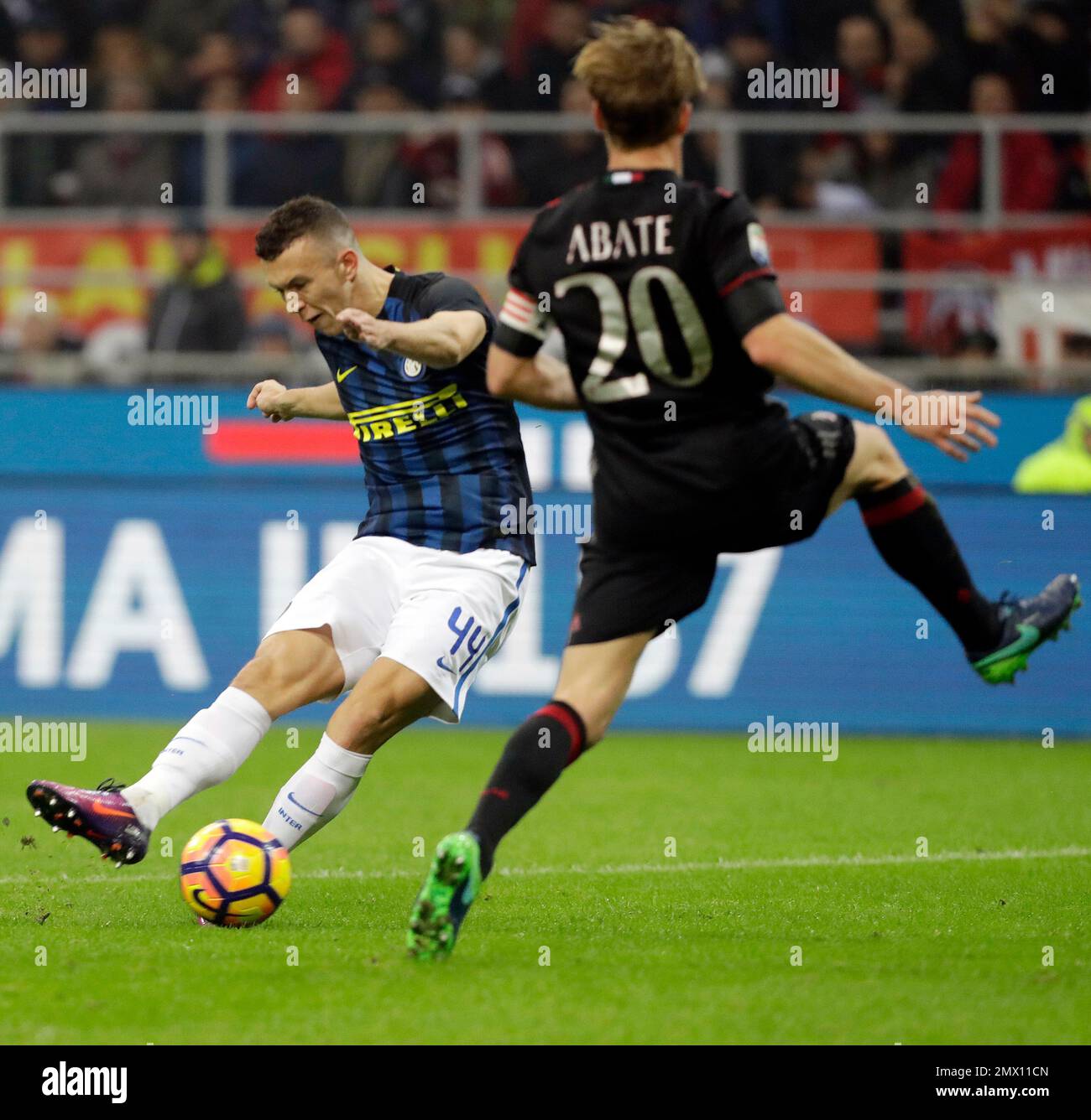 Inter Milan's Ivan Perisic, left, tries to score past AC Milan's ...