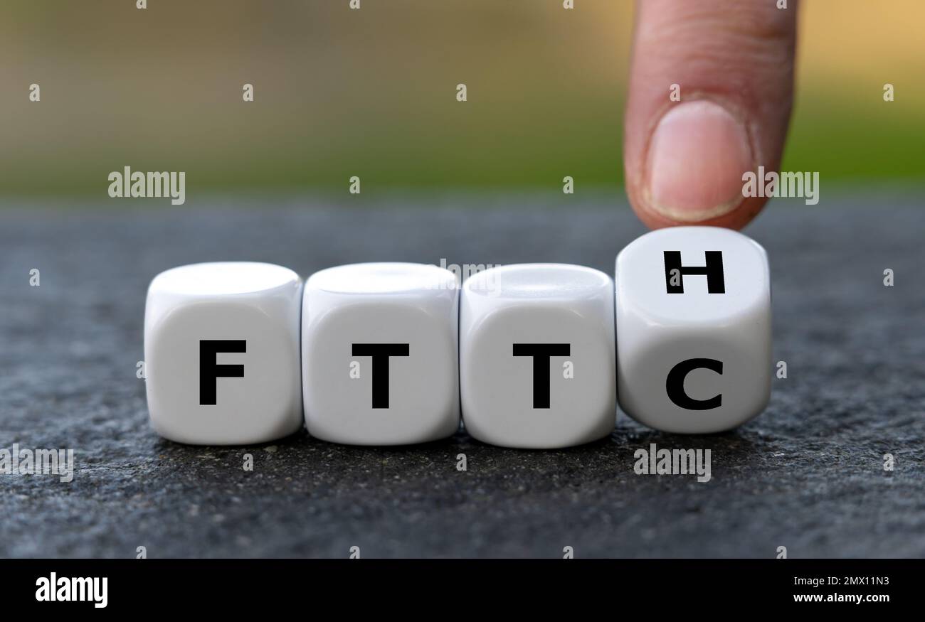 Hand turns dice and changes the expression Fiber to the curb (FTTC) to ...