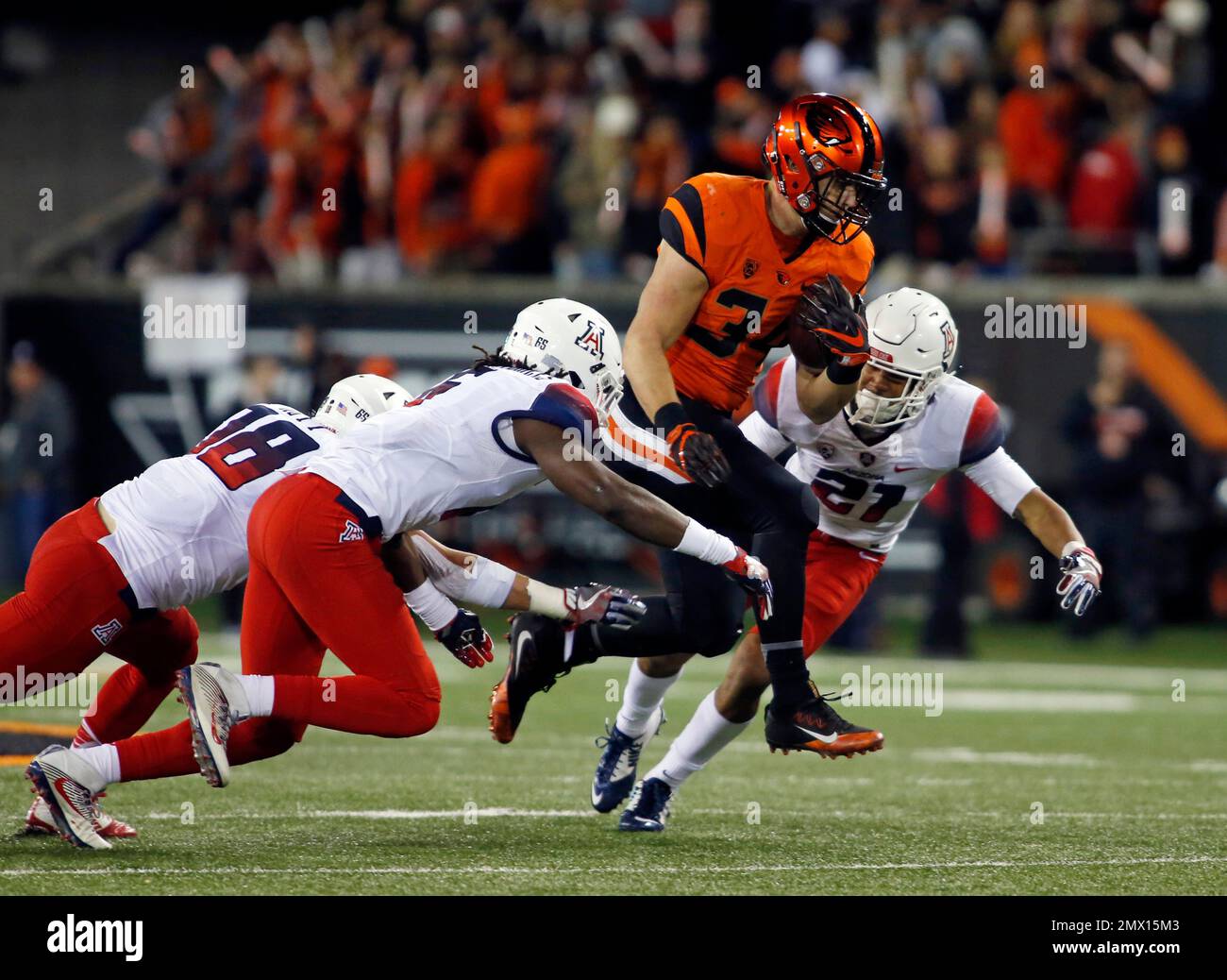 Oregon State running back Ryan Nall (34) tries to get away from a trio ...