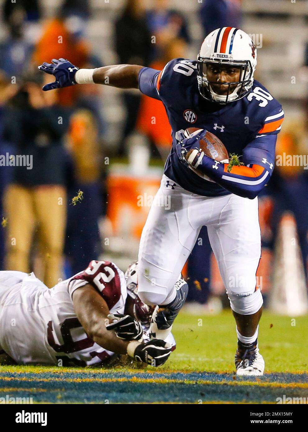 Auburn running back Damian Lewis (30) carries the ball as he tries to ...