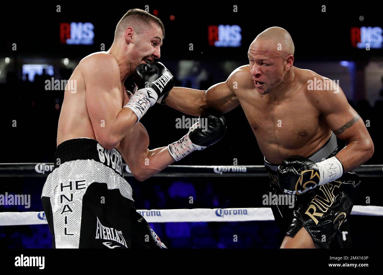 Oleksandr Gvozdyk, left, of Ukraine, is hit by Isaac Chilemba, of ...