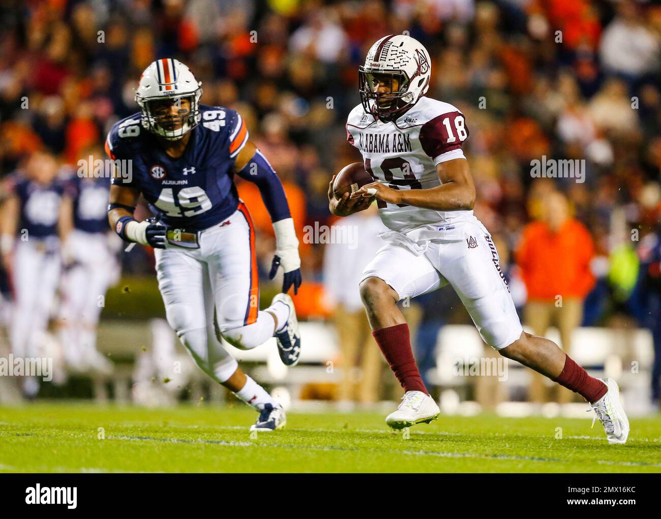 Alabama A&M quarterback De'Angelo Ballard (18) scrambles around Auburn ...