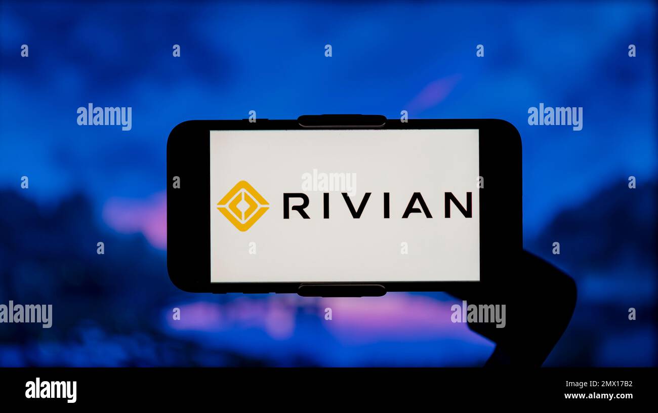 In this photo illustration, Rivian logo is seen displayed on a mobile ...