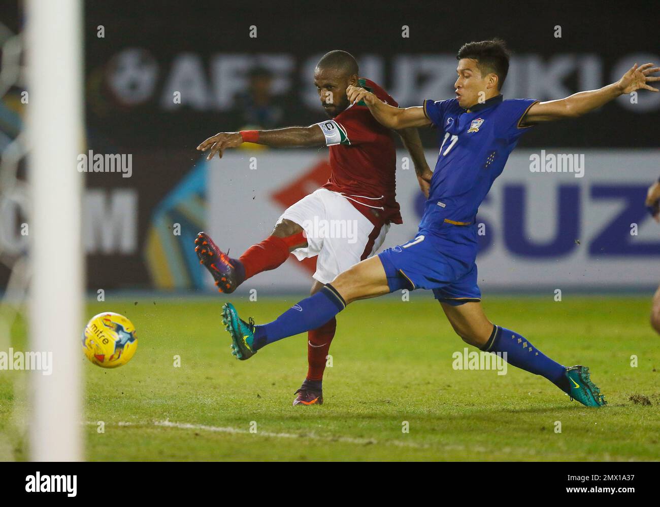 Indonesia's striker Boaz Solossa, left, attempts to score over Thailand ...