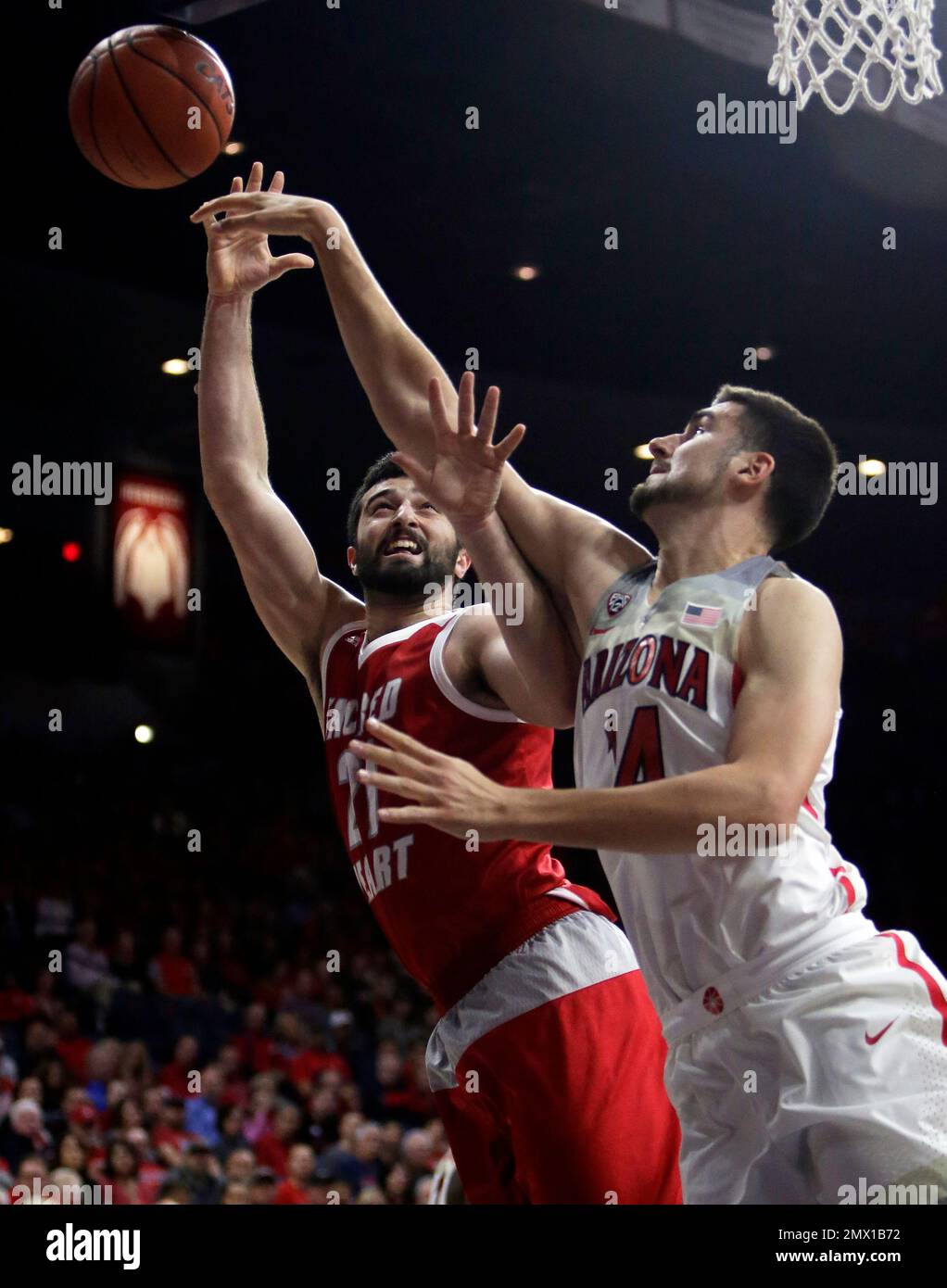 Arizona center Dusan Ristic (14) blocks the shot of Sacred Heart ...