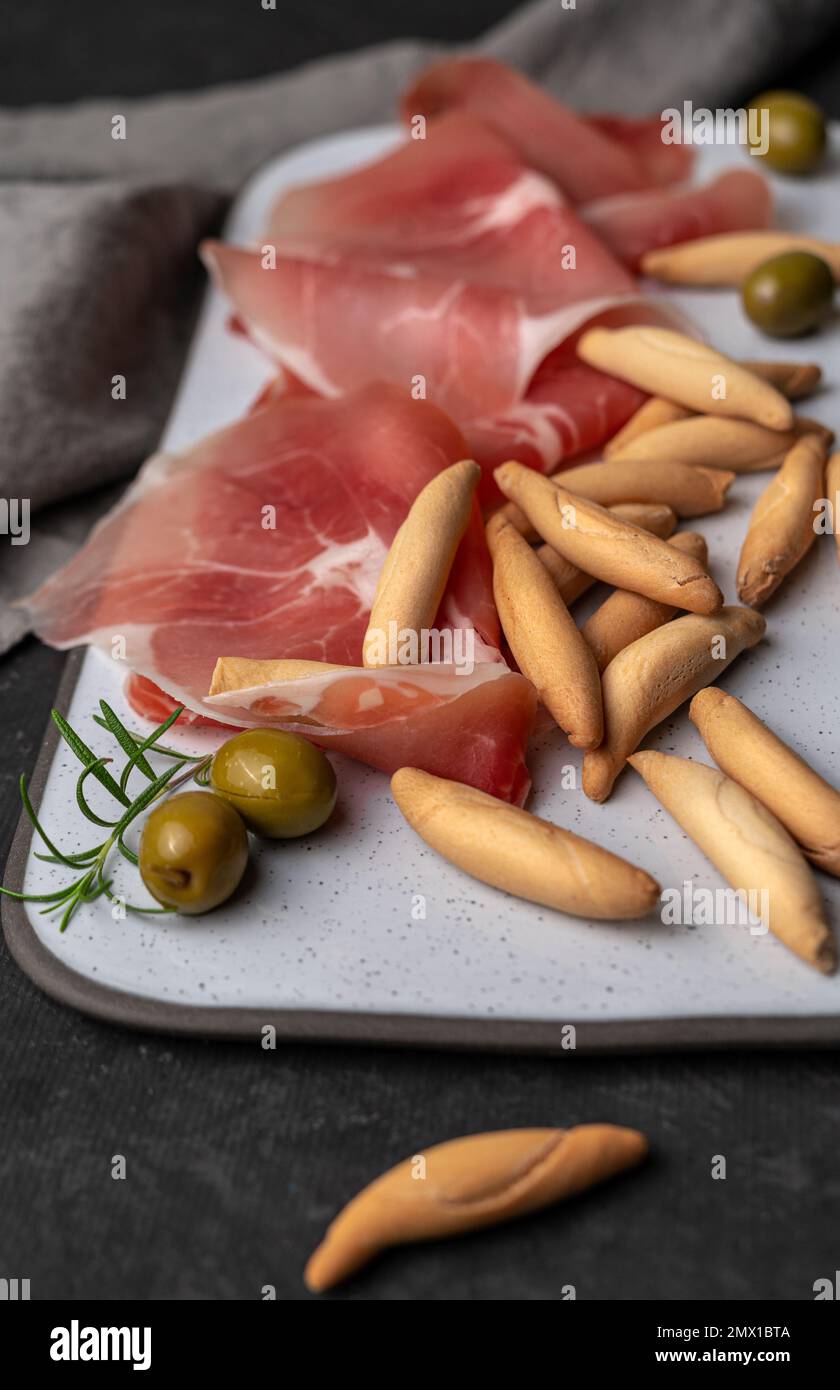 Spanish jamon and picos on desk Stock Photo - Alamy