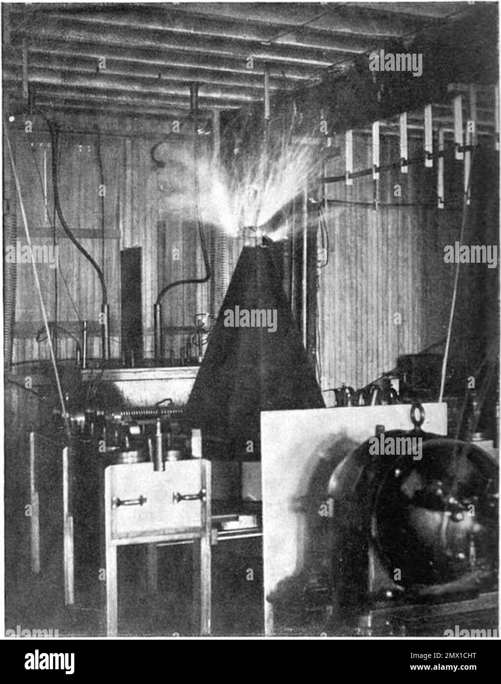 One of Tesla's early coils at his New York lab in 1892, with a conical ...