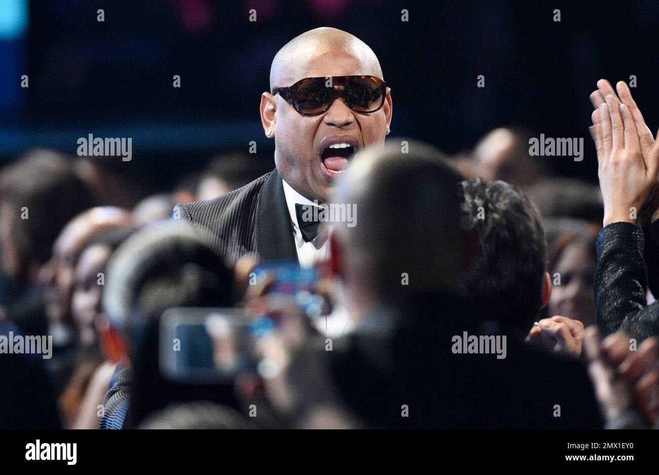 Alexander Delgado, of Gente de Zona, accepts the award for best ...