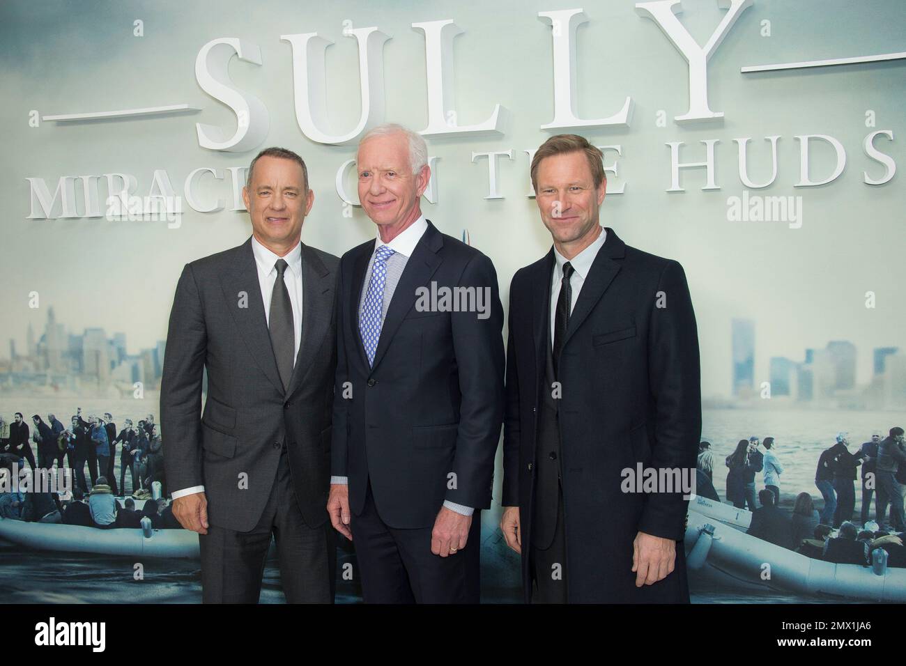 Actors Tom Hanks, left, and Aaron Eckhart, right, pose for photographers alongside retired ...