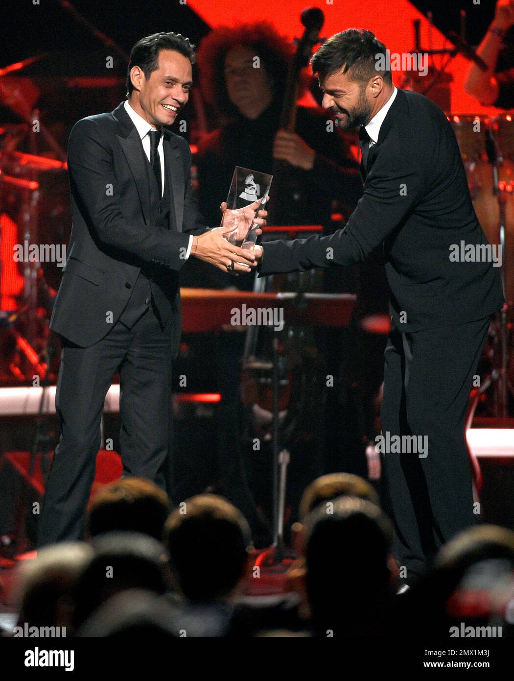 Honoree Marc Anthony, left, accepts the award for the Latin Recording ...