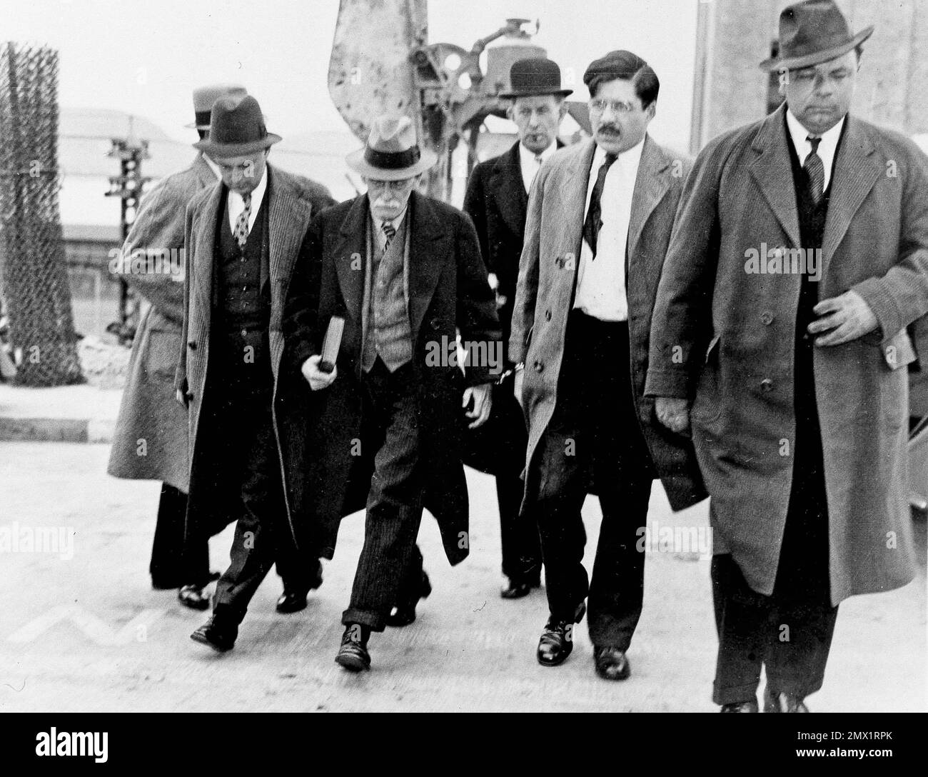 Albert H. Fish, carrying bible, is shown handcuffed to Lawrence Stone ...