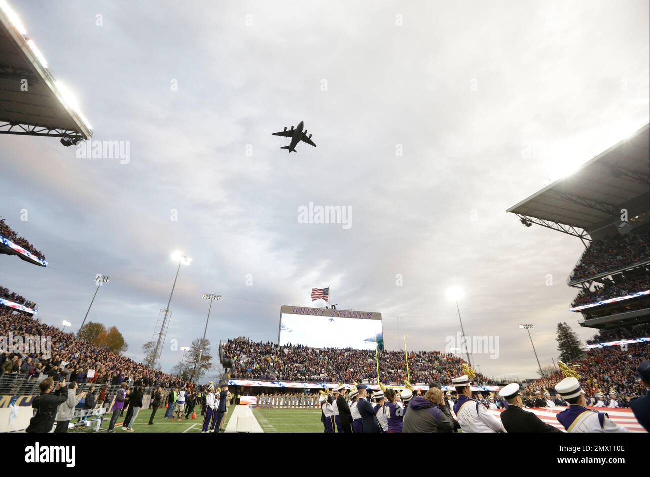 A military aircraft performs a fly-over of Husky Stadium before an NCAA ...