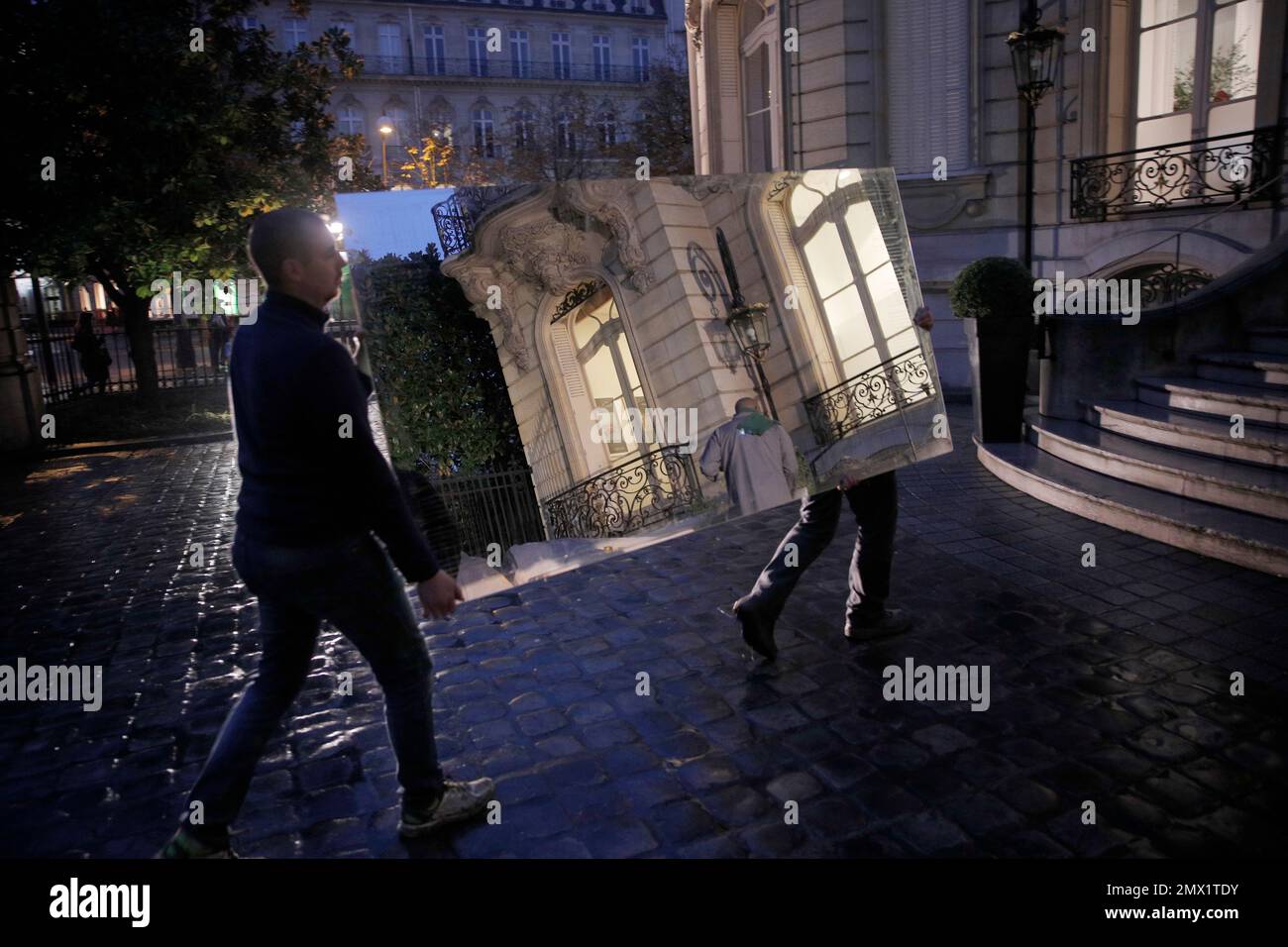 Auction house employees carry a mirror at the Artcurial auction house ...
