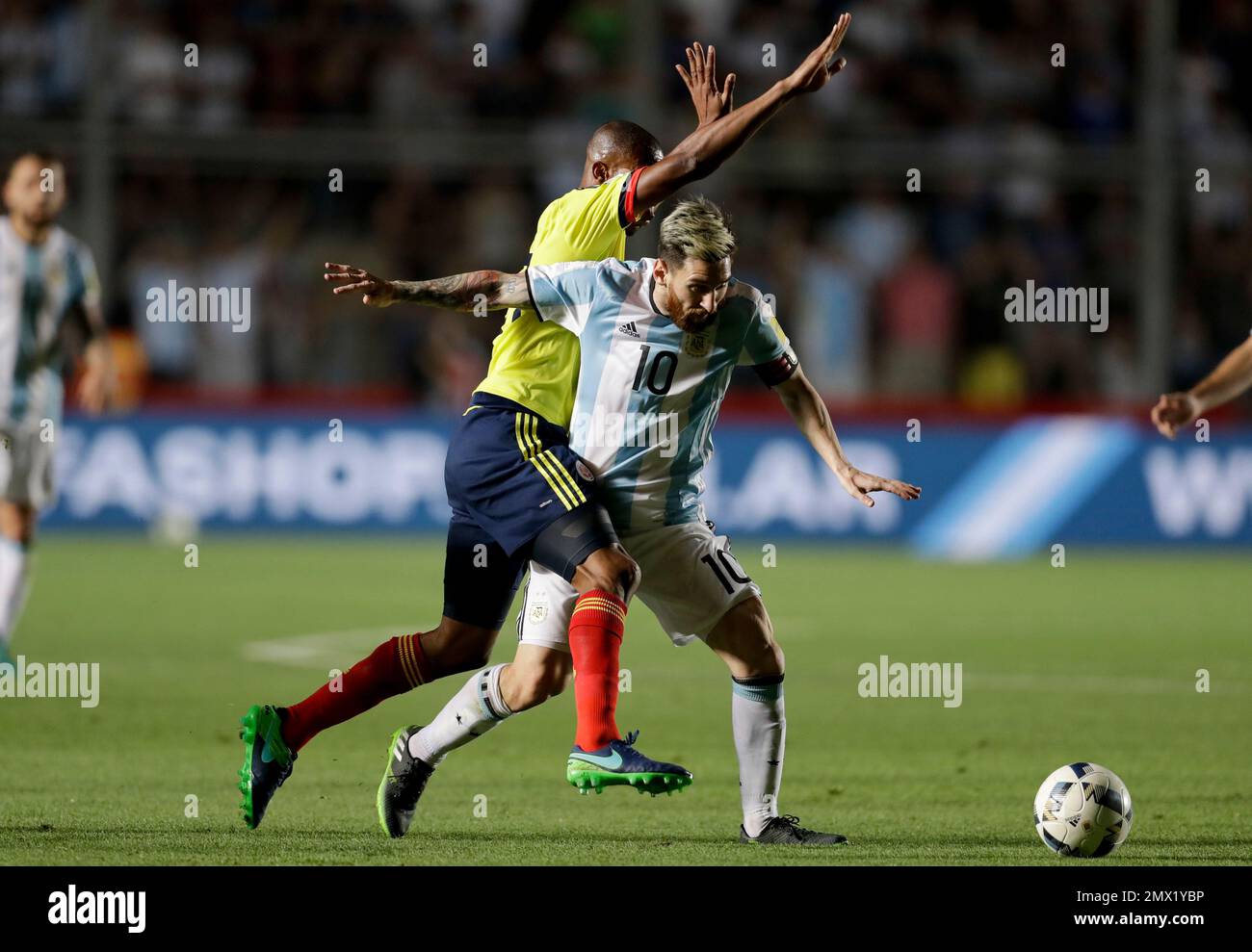Colombia's Jonathan Copete, left, fouls Argentina's Lionel Messi during ...