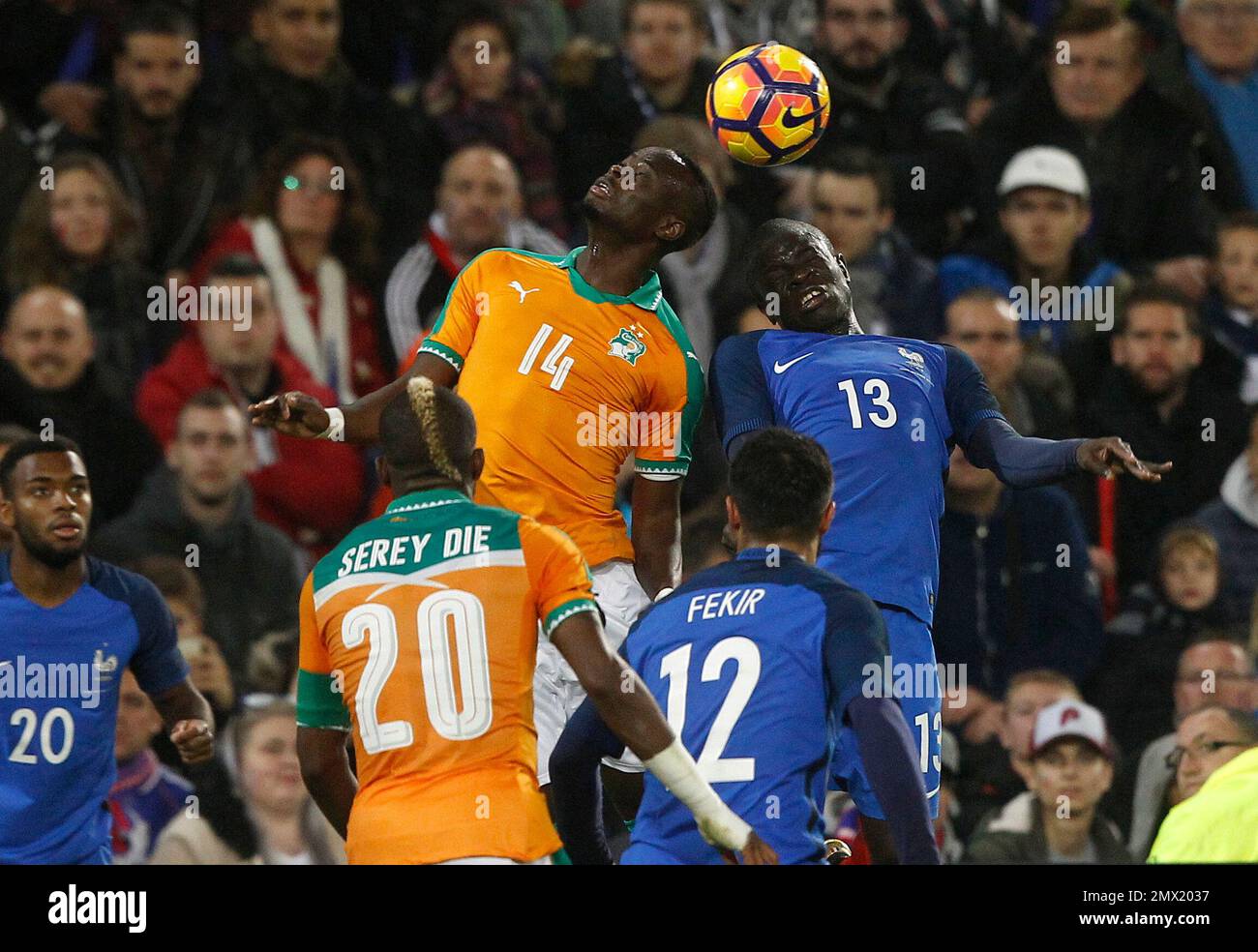 Ivory Coast's Ismael Diomande, left, and France's N'Golo Kante jump for ...