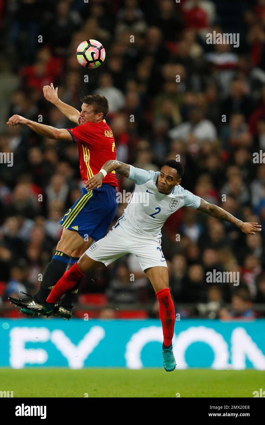 Spain's Cesar Azpilicueta, left, and England's Nathaniel Clyne jump to ...