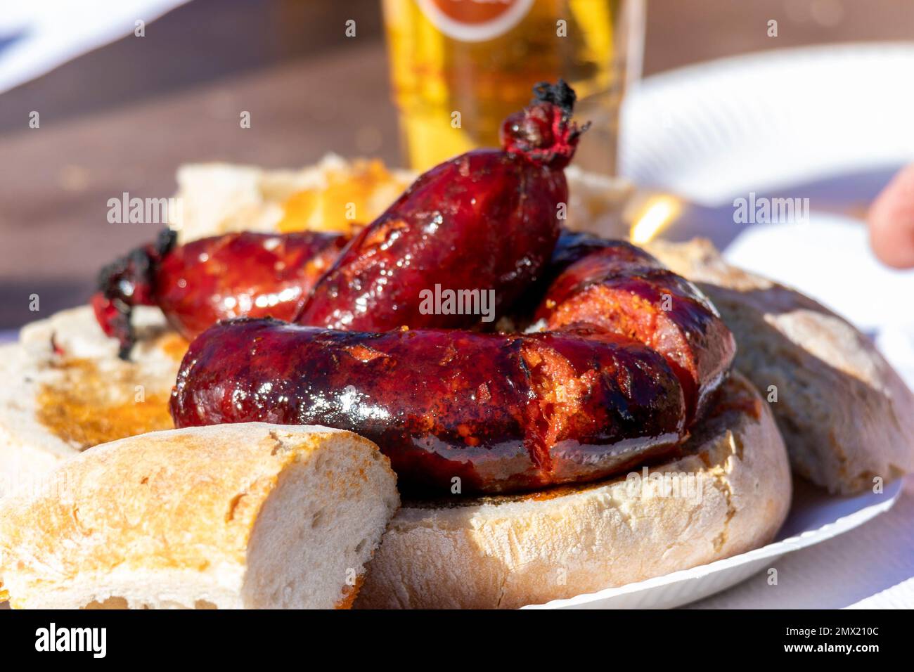 Grilled chorizo on top of bread with beer served on the Fiesta of the ...