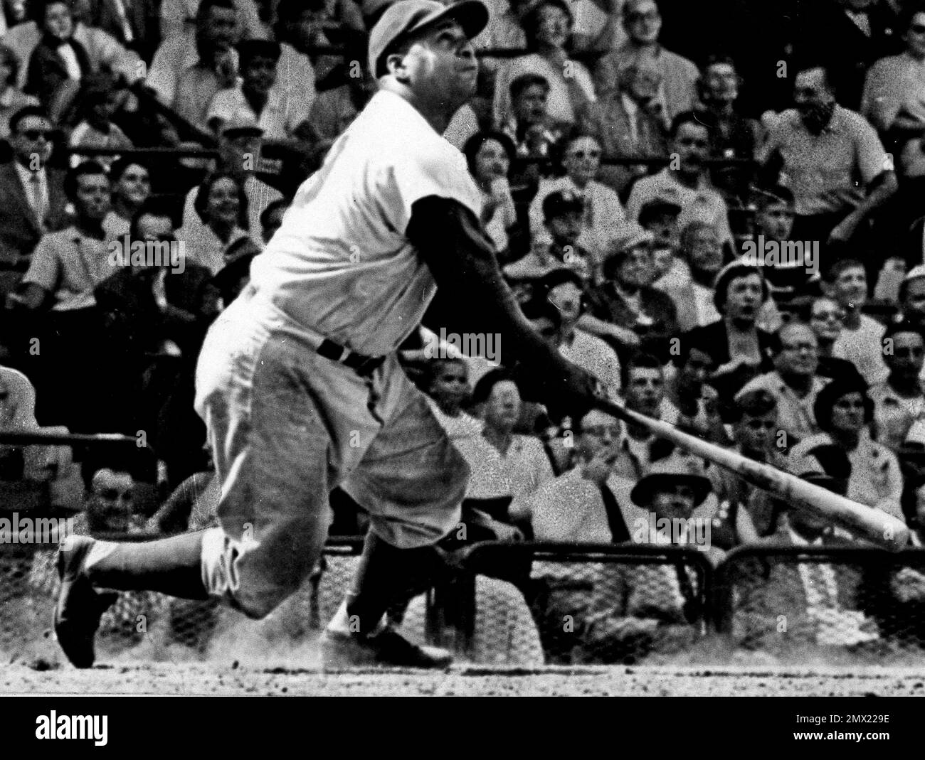 Brooklyn Dodgers catcher Roy Campanella goes down on one knee as he ...