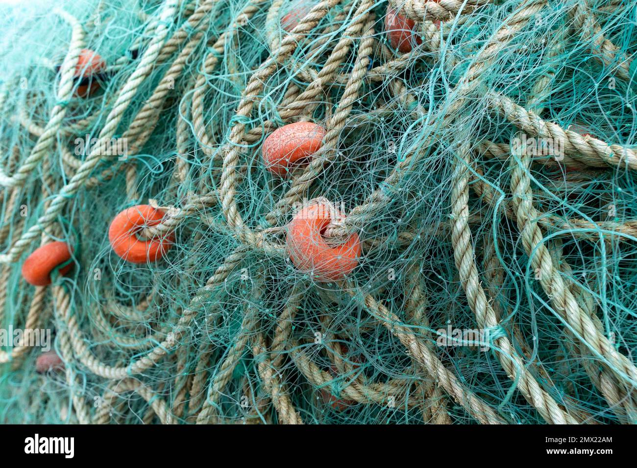 Pile of traditional fishing nets for catching fish, on Olhao city docks ...