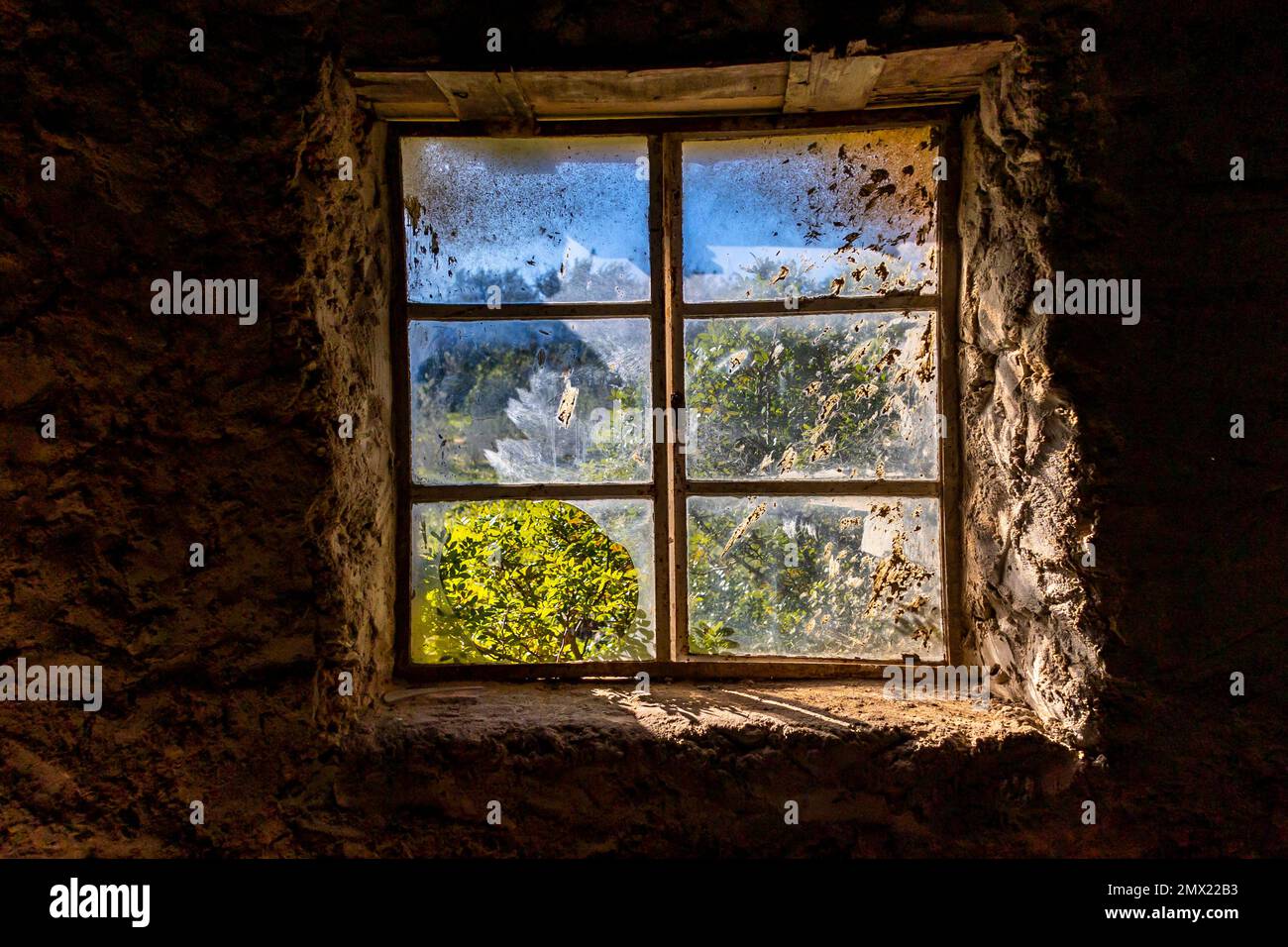 old dirty window on a abandoned building looking from the interior to ...
