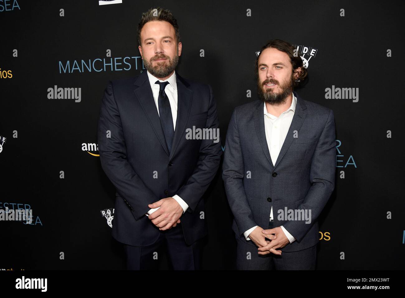 Casey Affleck, right, a cast member in "Manchester by the Sea," poses ...