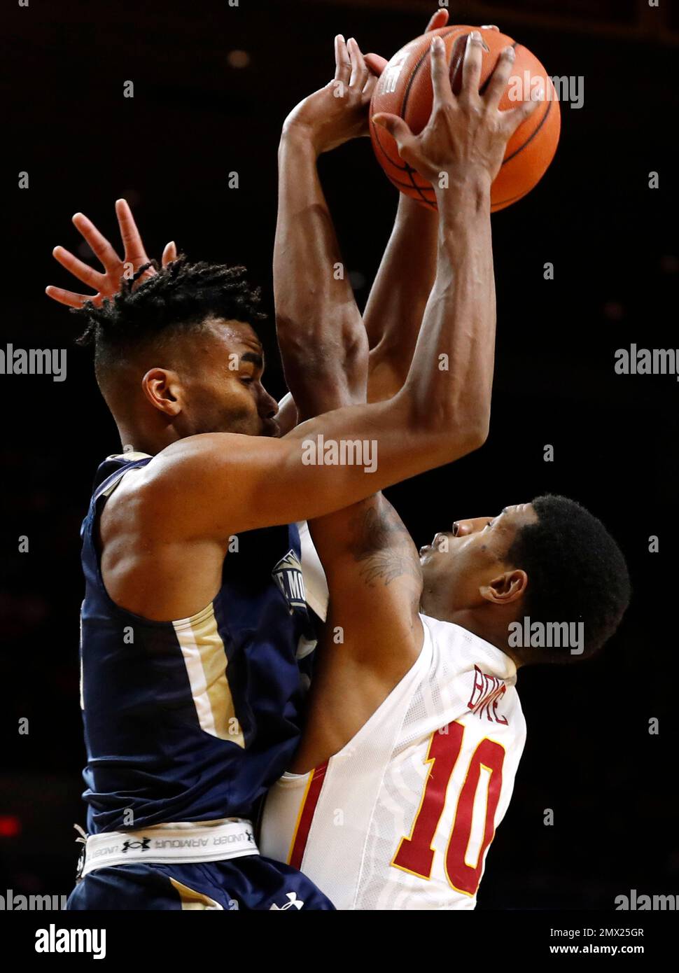 Mount St. Mary's forward Chris Wray, left, fights for a rebound with ...