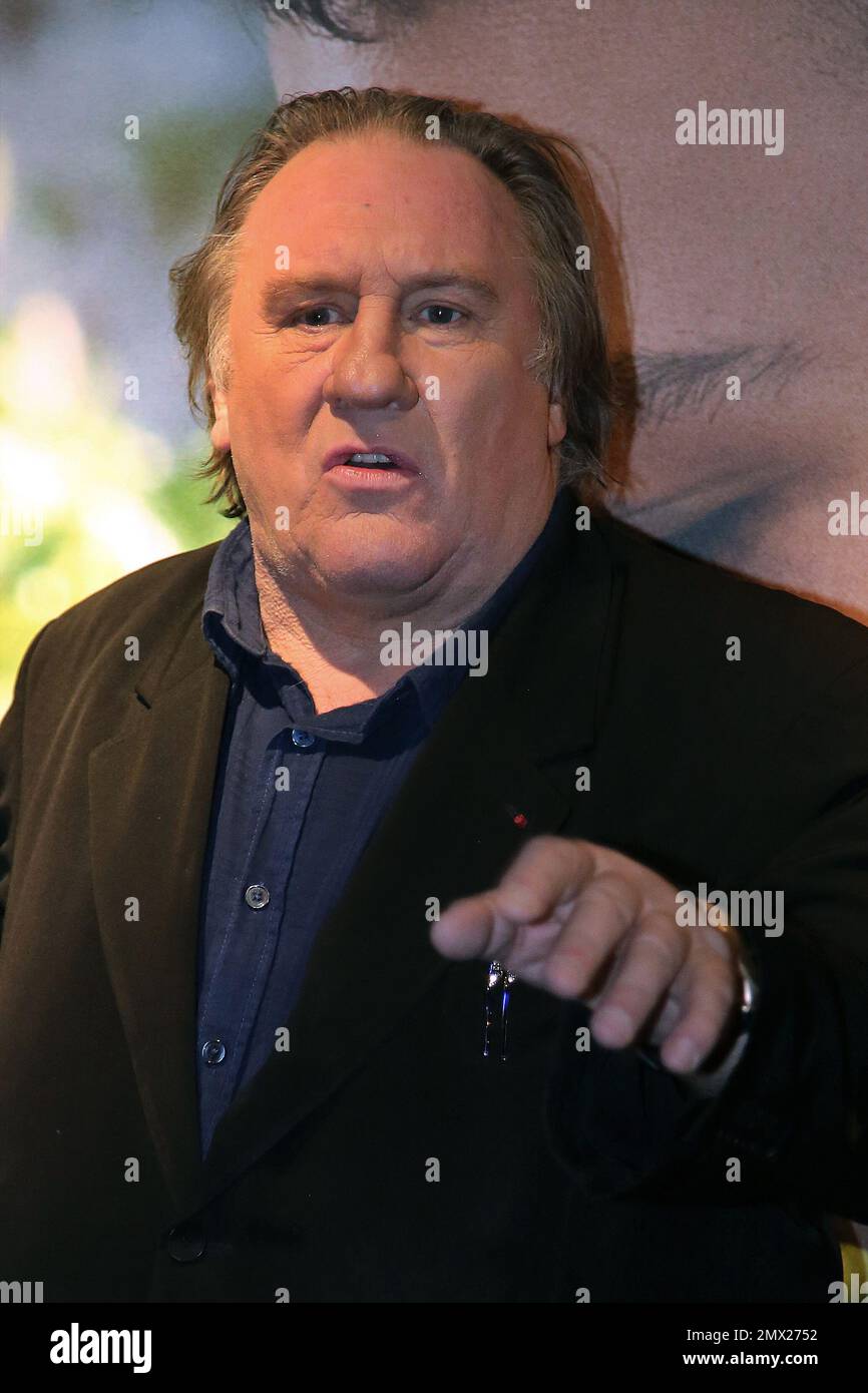 Actor Gerard Depardieu waves to photographers during the premiere of ...