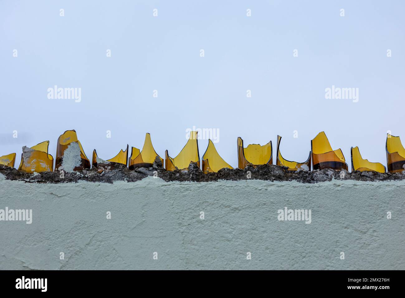 View of broken glass shards on wall for prevention of burglary Stock ...