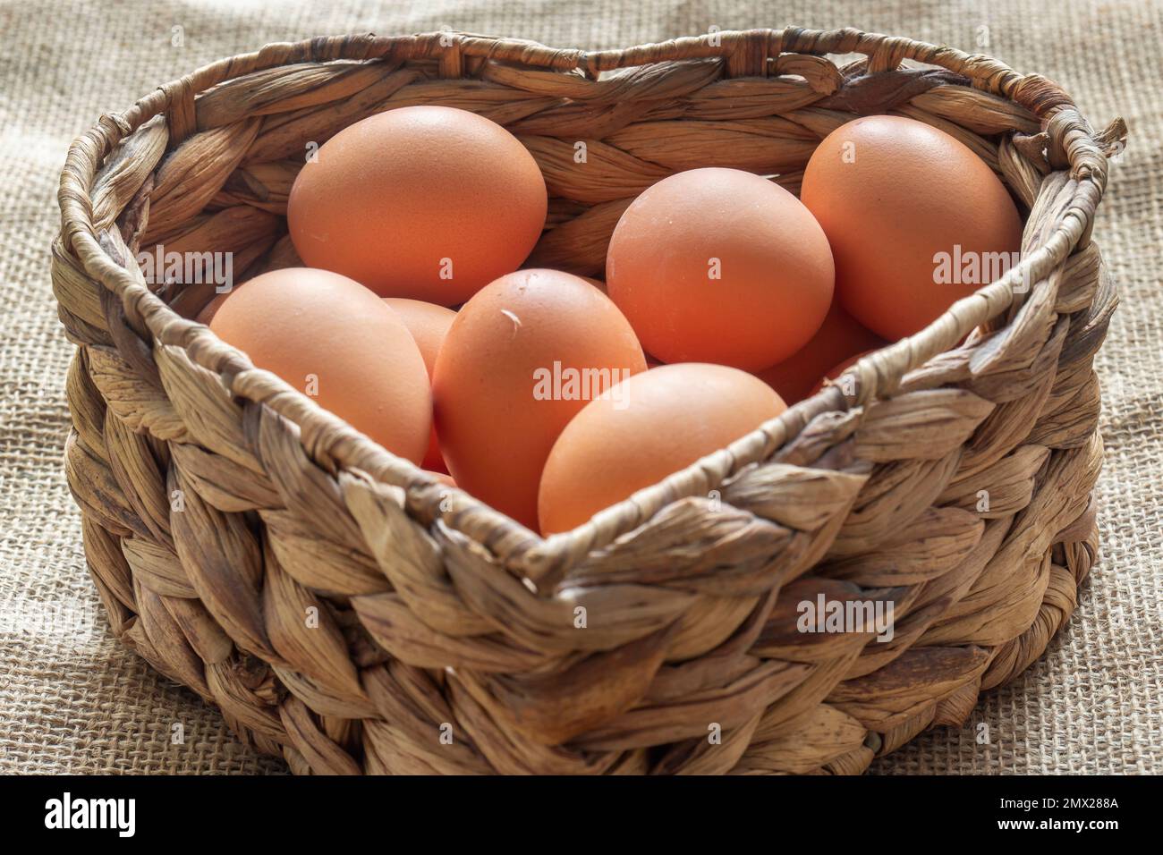 Free range chicken eggs in a heart shaped water hyacinth wicker basket ...