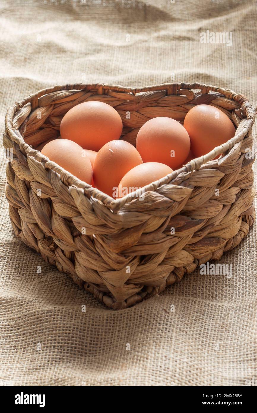 Free range chicken eggs in a heart shaped water hyacinth wicker basket ...