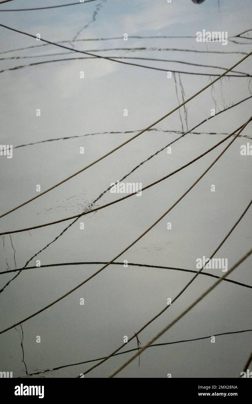 Abstract view of many ropes crossed between each other Stock Photo - Alamy