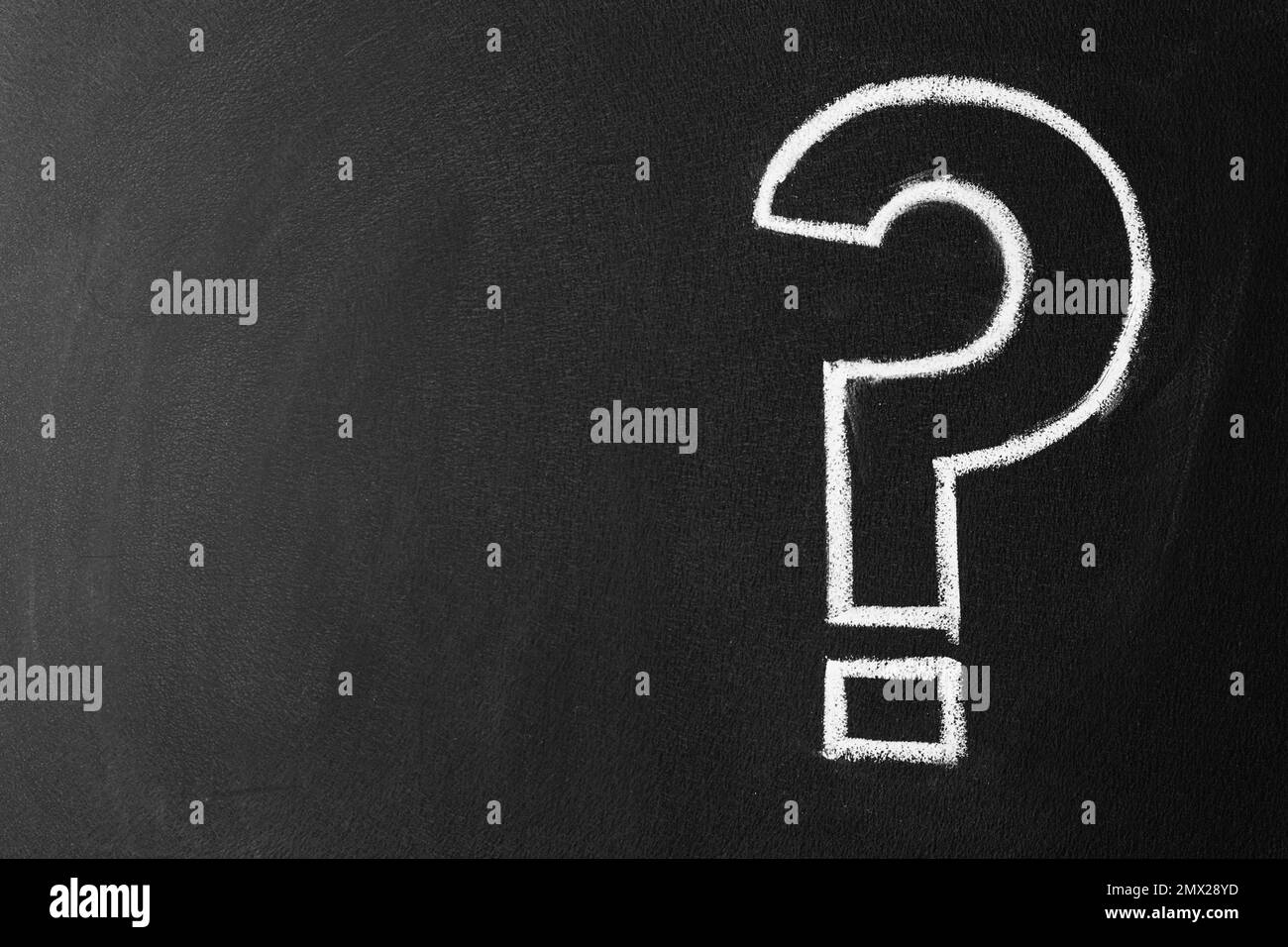 Question mark drawn with chalk on blackboard, top view. Space for text ...